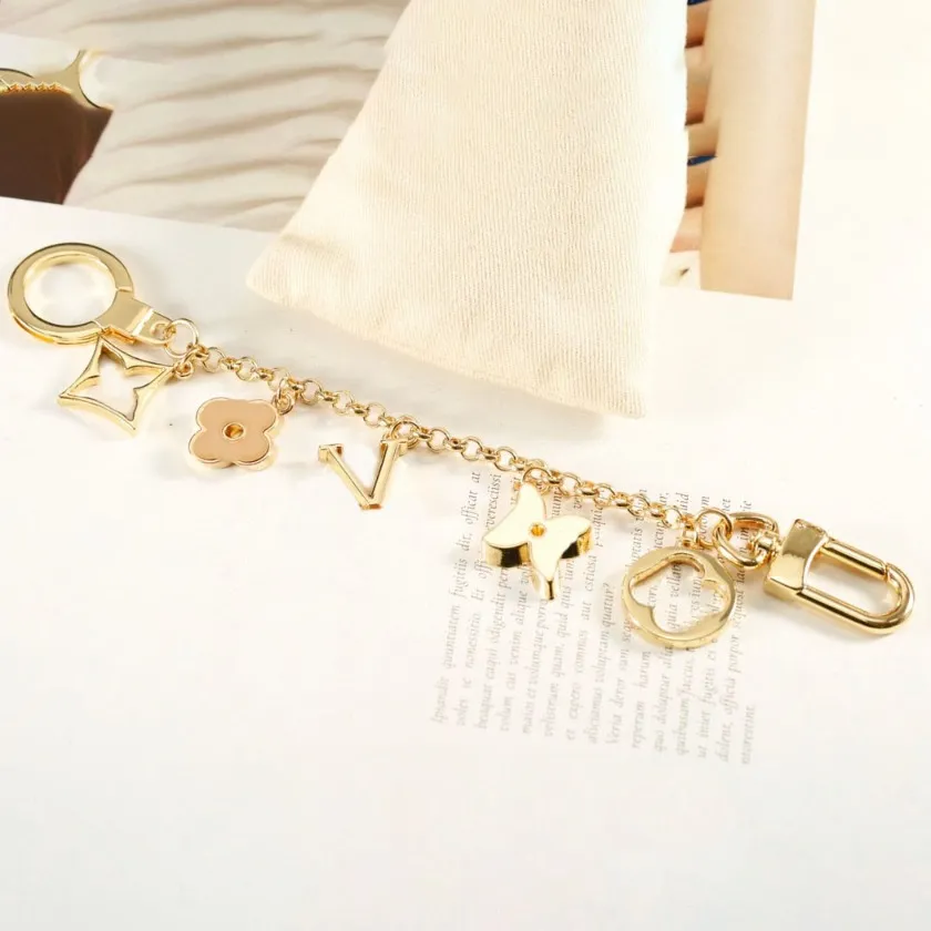 Gold Tone Dual Clasp Bag Key Charm With Enamel Flower, Leaf, Letter V ...