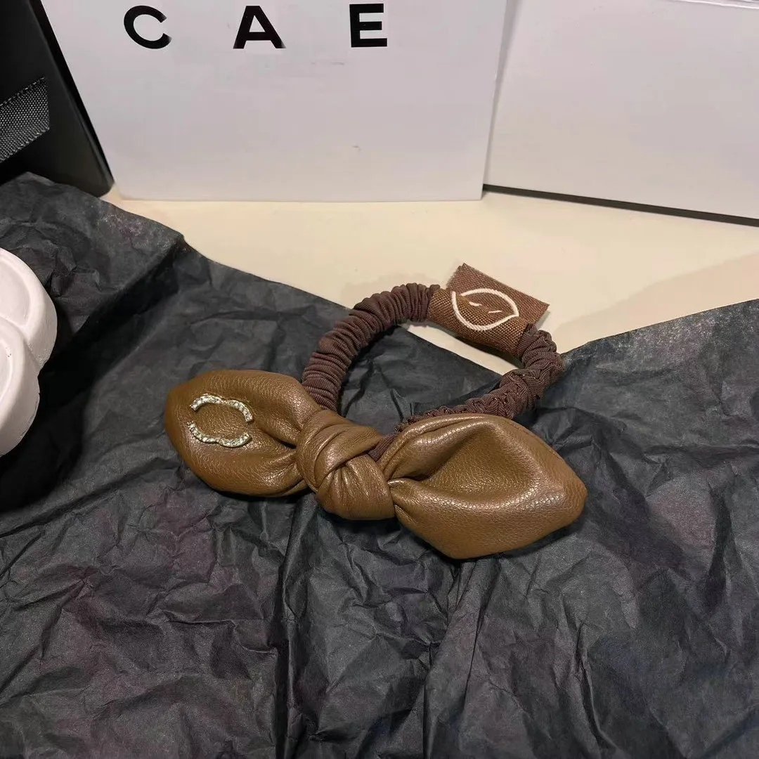 DHgate.com:Leather Bow Scrunchies: Premium Designer Hair Accessories ...