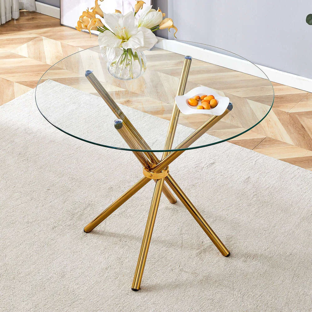 Round glass dining table with clear top and ring-shaped gold metal legs ...